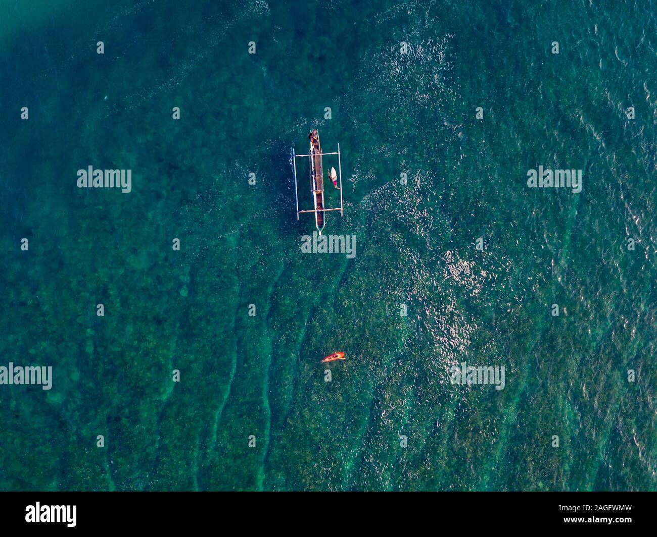 Aerial view of surfer and boat in the ocean Stock Photo - Alamy