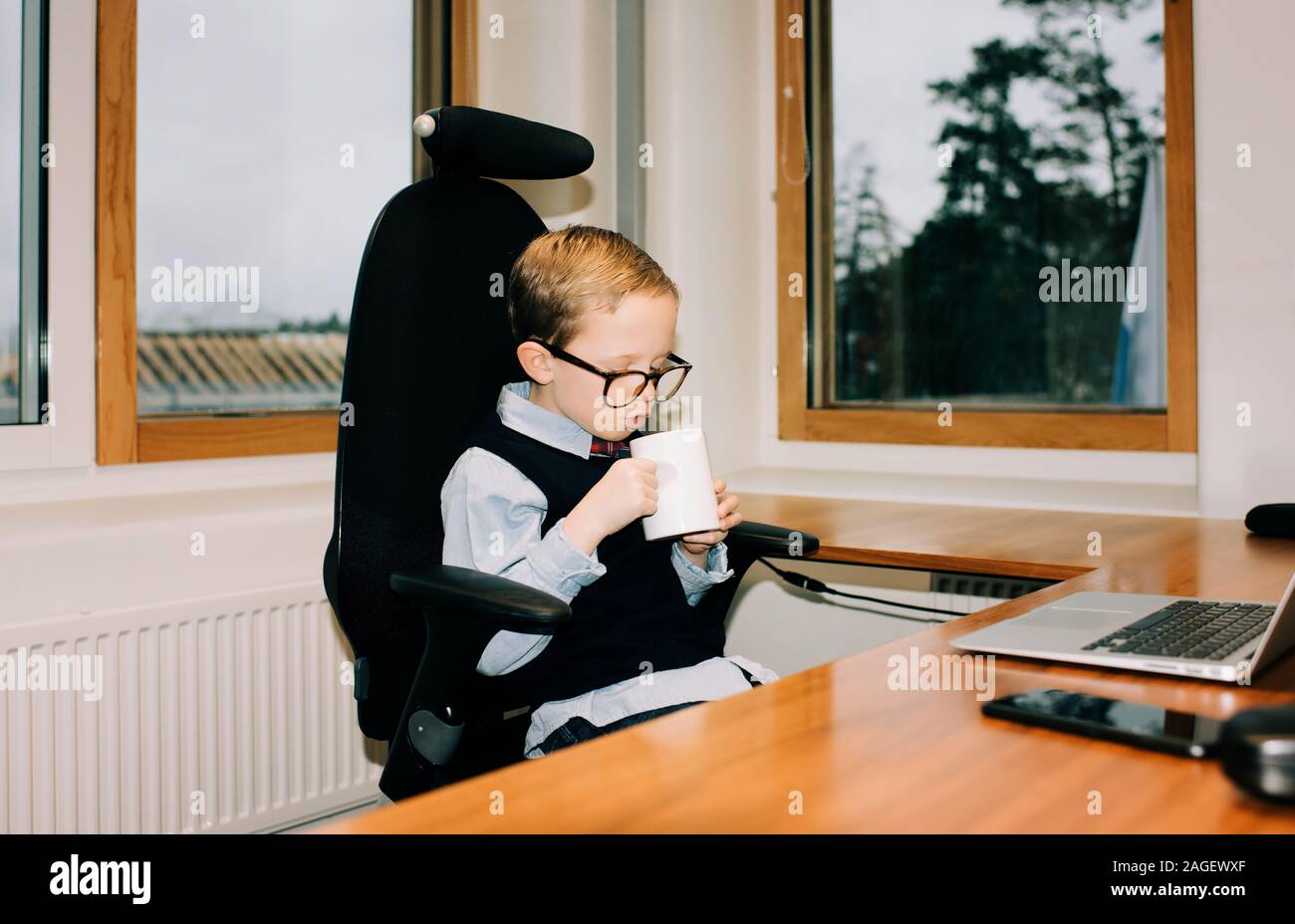 young boy drinking coffee in his dads office at work Stock Photo - Alamy