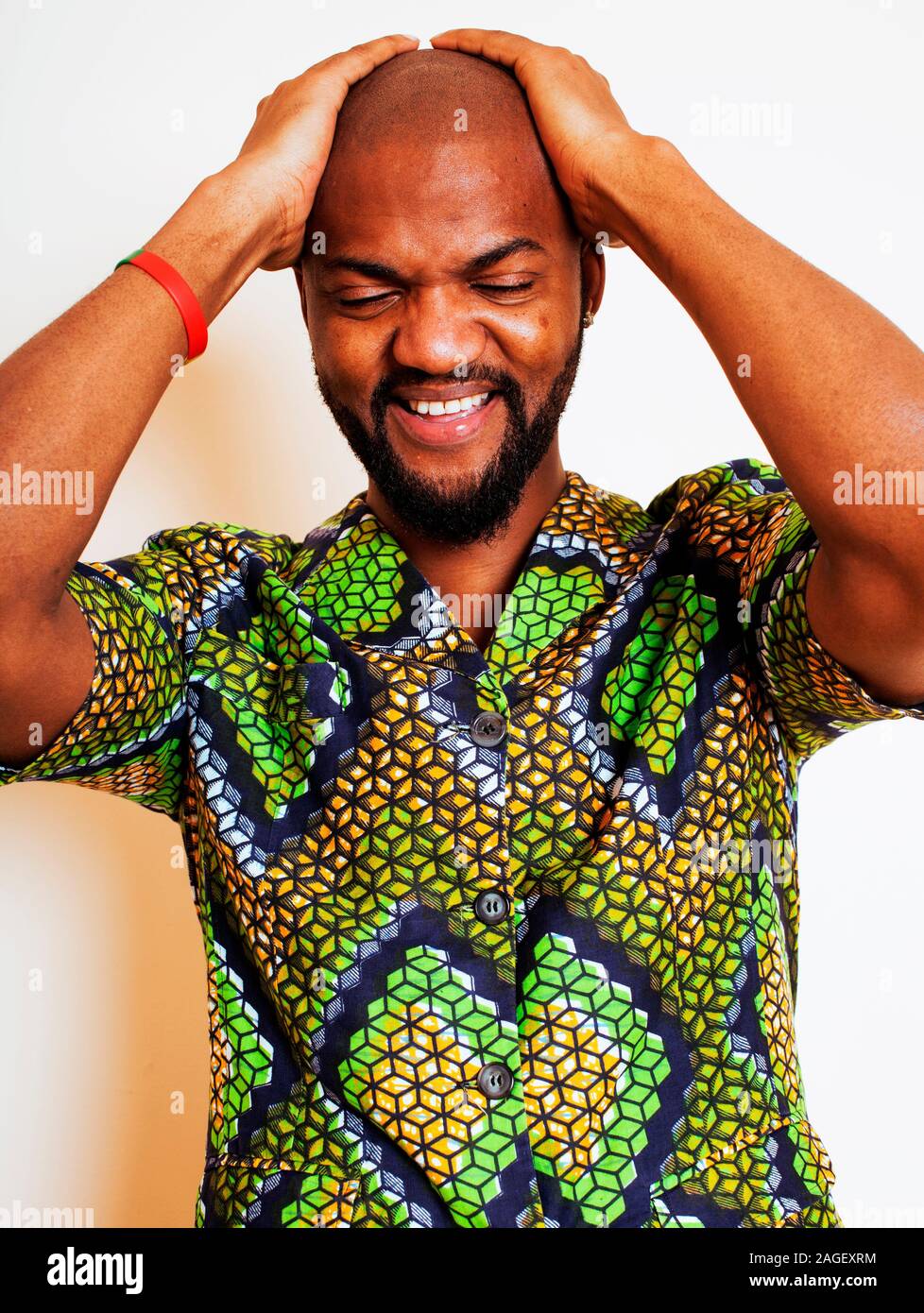 portrait of young handsome african man wearing bright green national ...