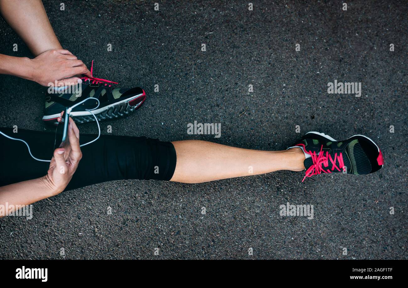 Runner girl stretching legs on hi-res stock photography and images - Alamy
