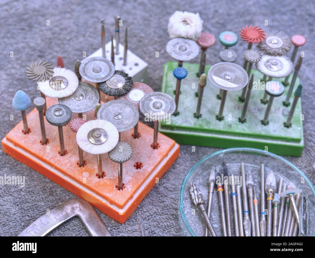 Special dental tools drill burrs and denture polishers in holder on a ...