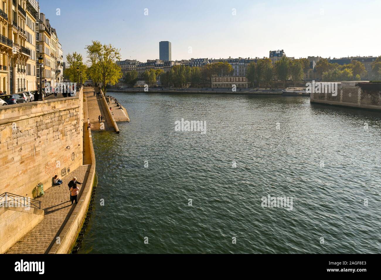 Scenic view of the Seine River from Pont Saint-Louis bridge with people and tourists in Quai d ...