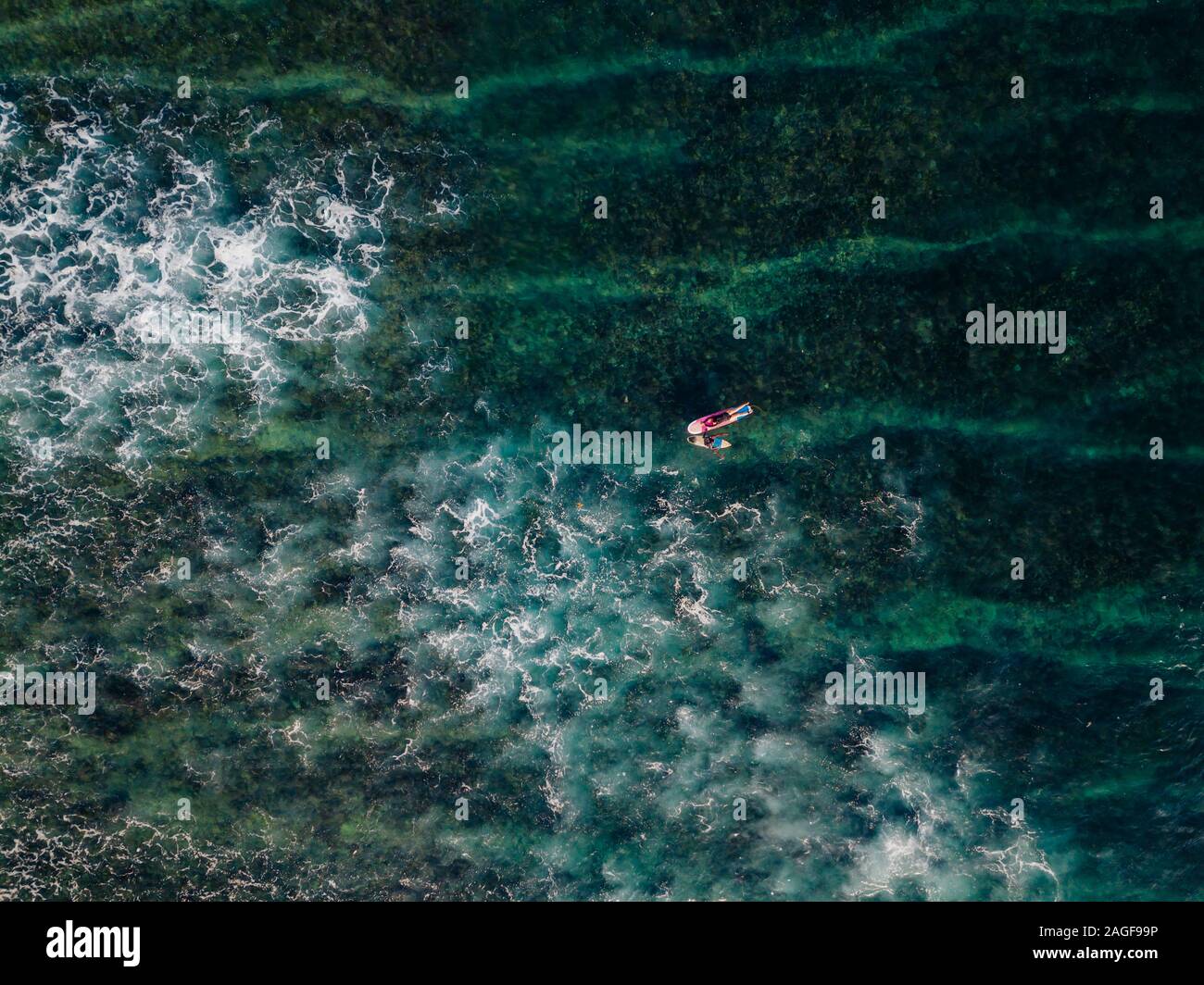 Aerial view of surfers in the ocean Stock Photo - Alamy