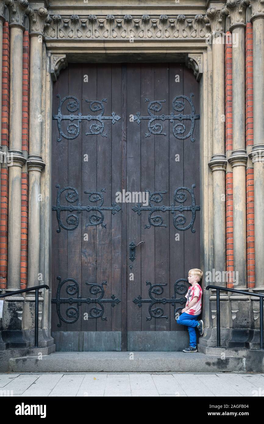 Boy leaning against door hi-res stock photography and images - Alamy