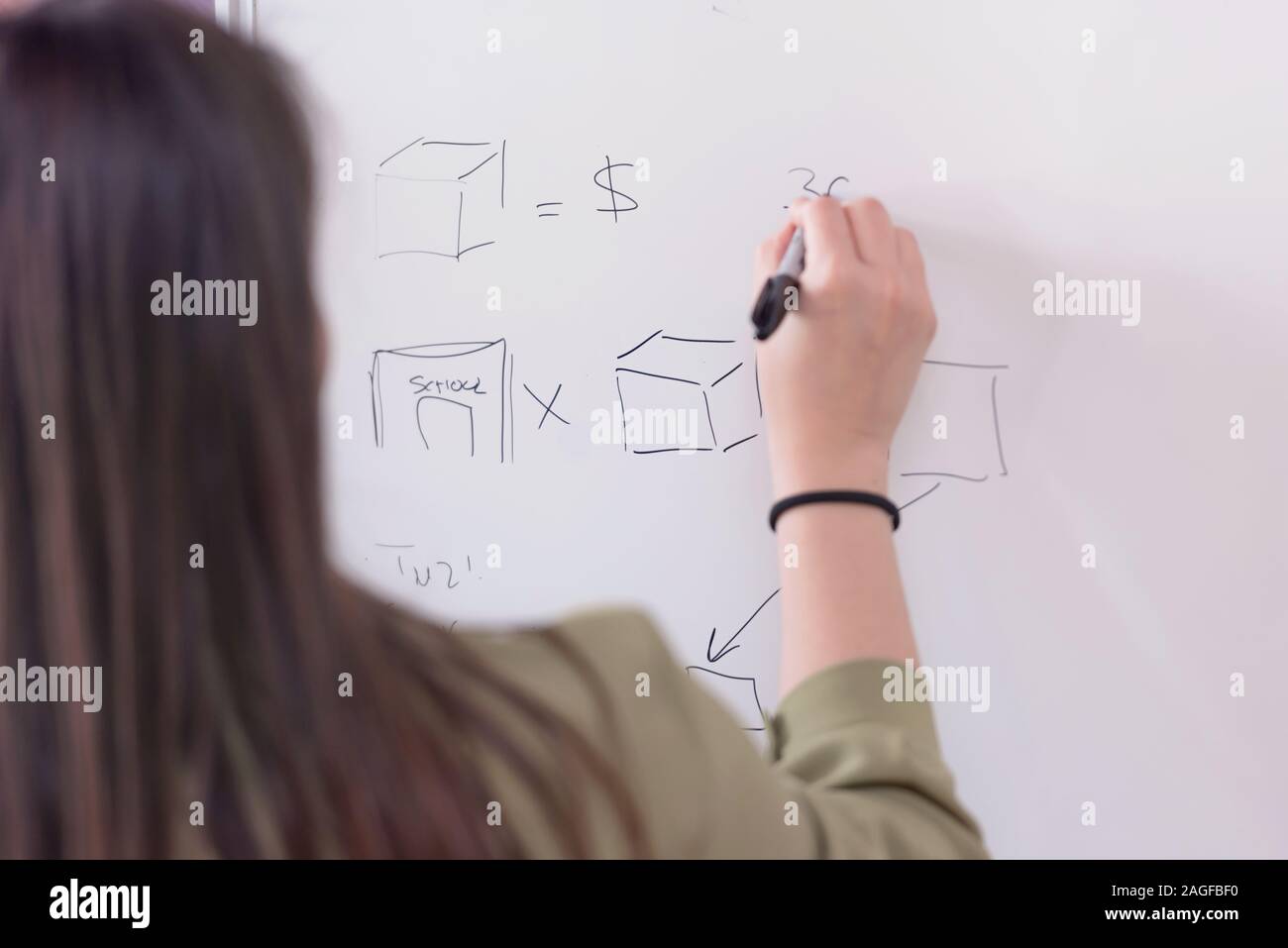 Young college female student writting on the chalkboard during a math ...