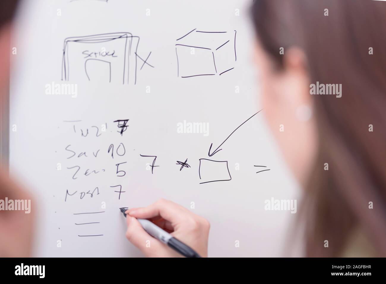 Two young college male and female students writting on the chalkboard ...