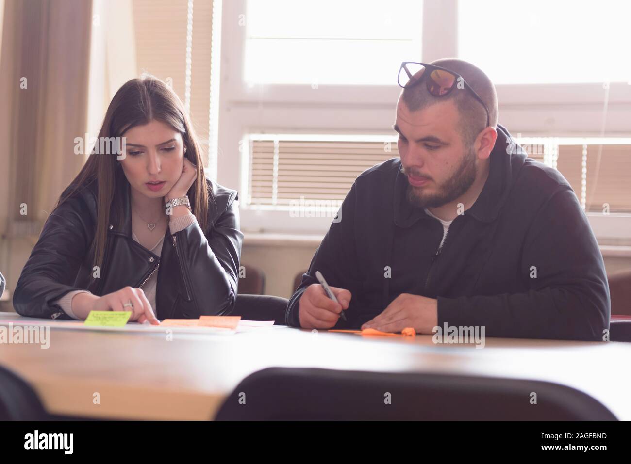 Two young female talented designers looking at innovative project ...