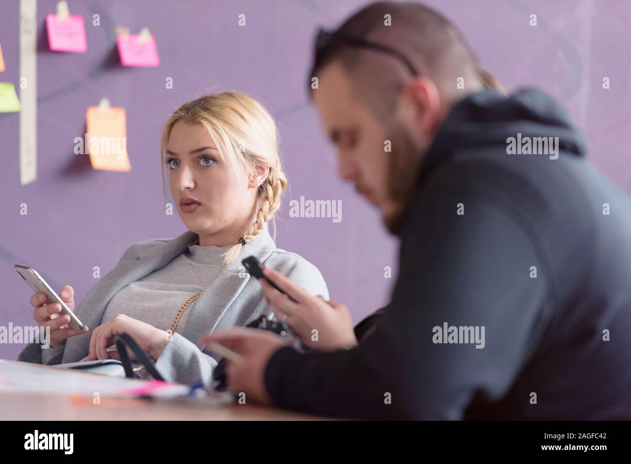 Group of young female talented designers looking at innovative project ...