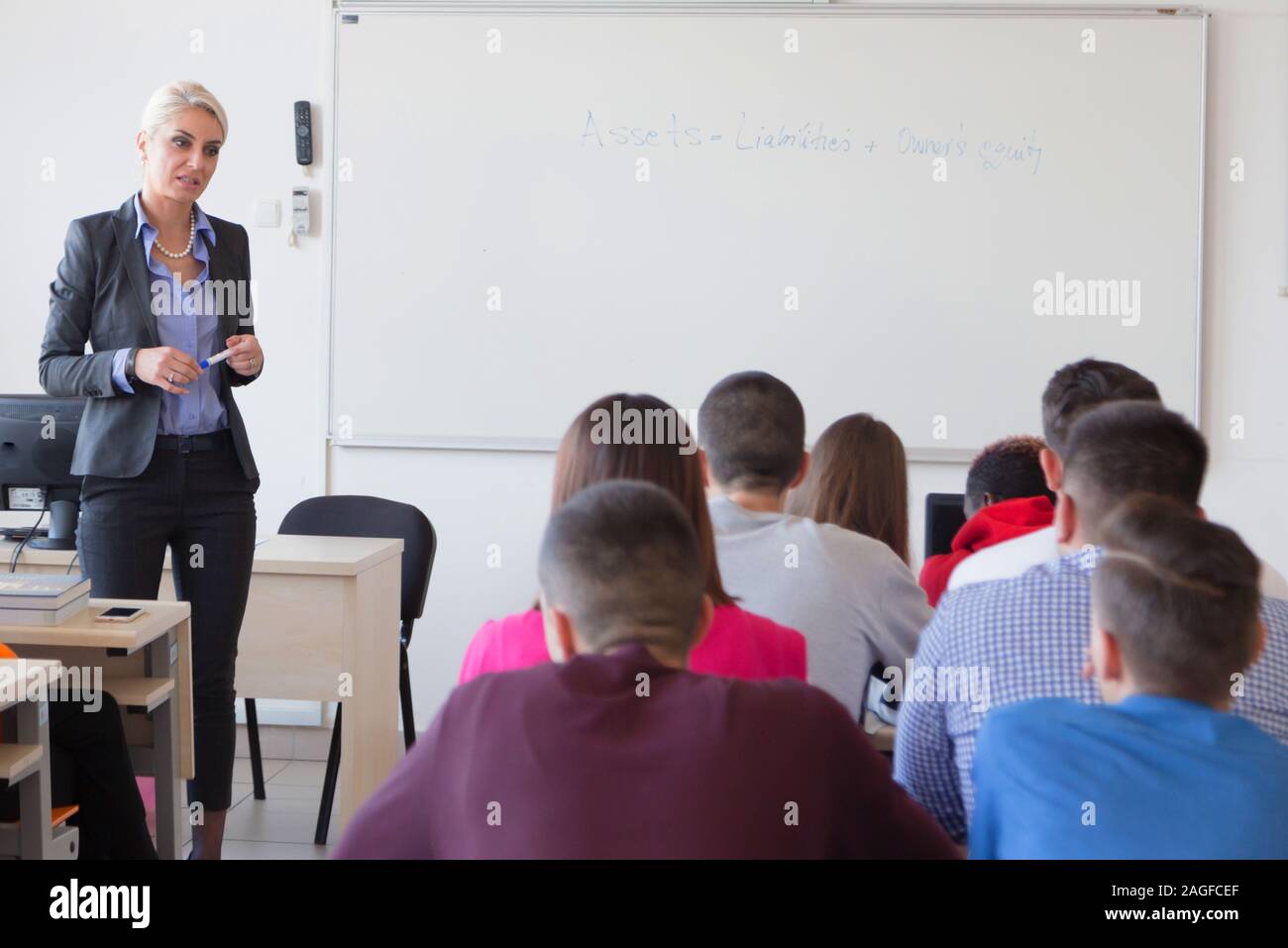 Female attractive professor explain lesson to students and interact ...