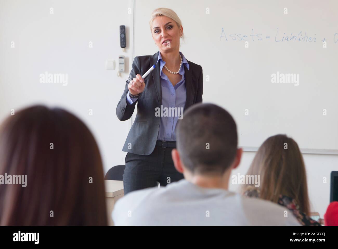 Female attractive professor explain lesson to students and interact ...