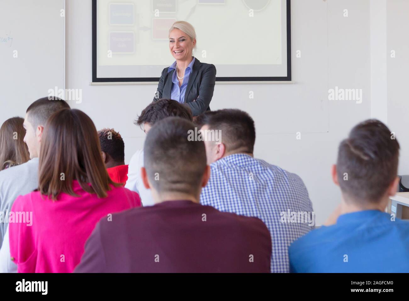 Female attractive professor explain lesson to students and interact ...