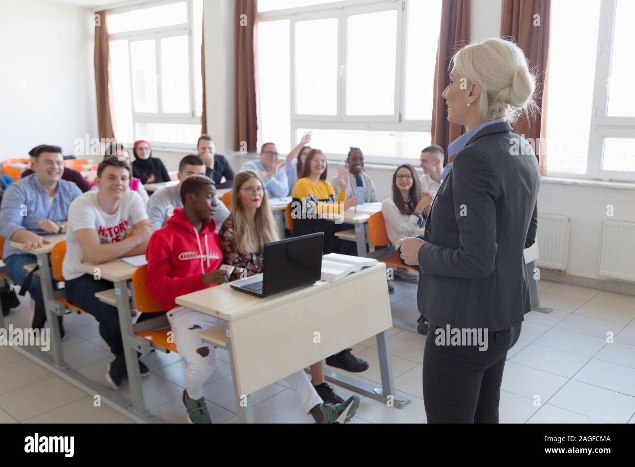 Female attractive professor explain lesson to students and interact ...