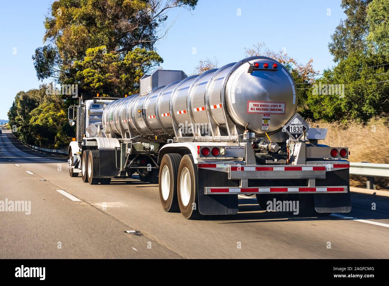 Tanker truck driving on the freeway Stock Photo - Alamy