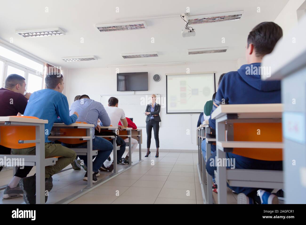Female attractive professor explain lesson to students and interact ...