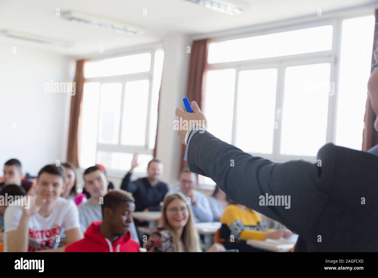 Female attractive professor explain lesson to students and interact ...