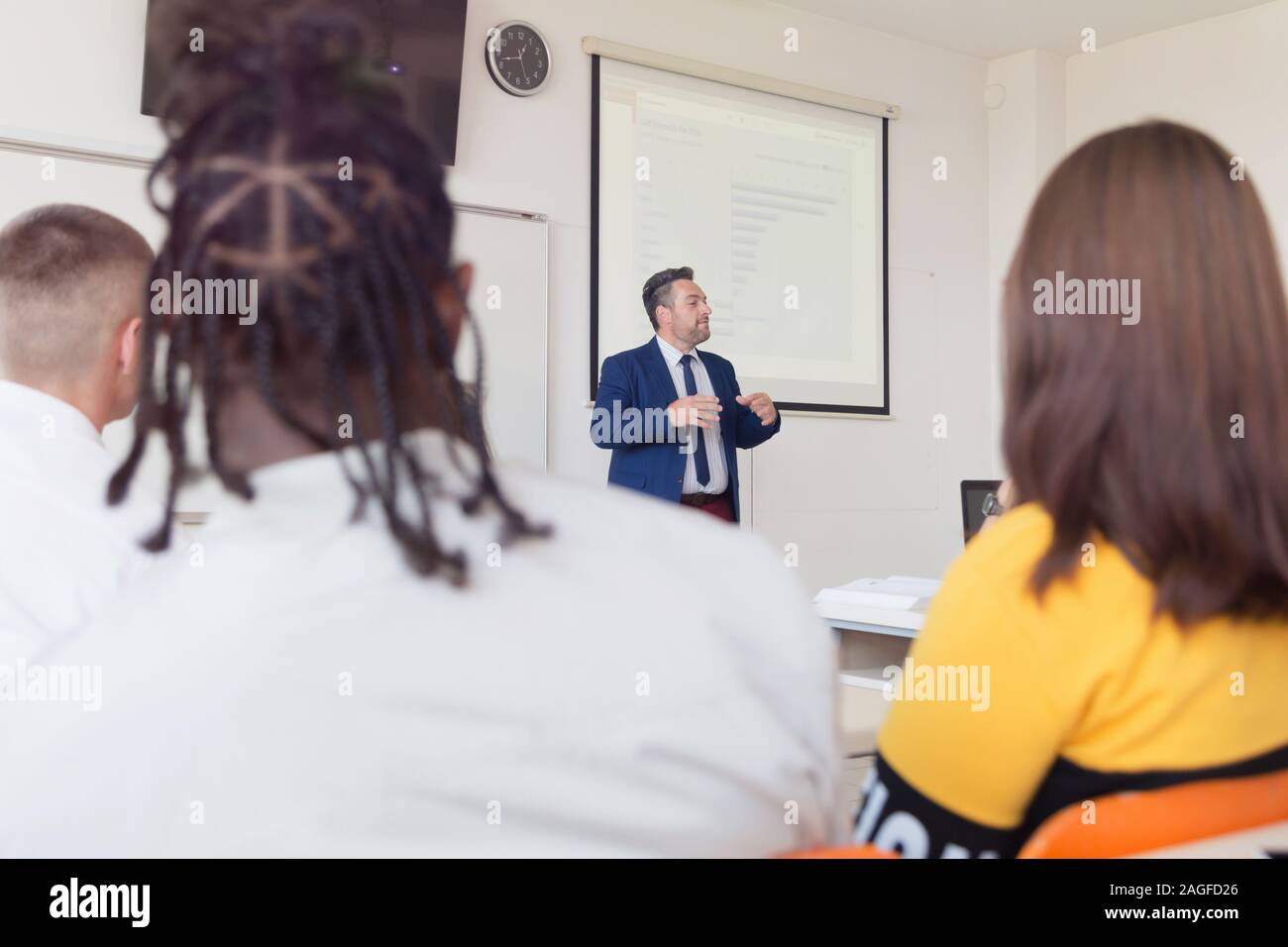 Male professor explain lesson to students and interact with them in the ...