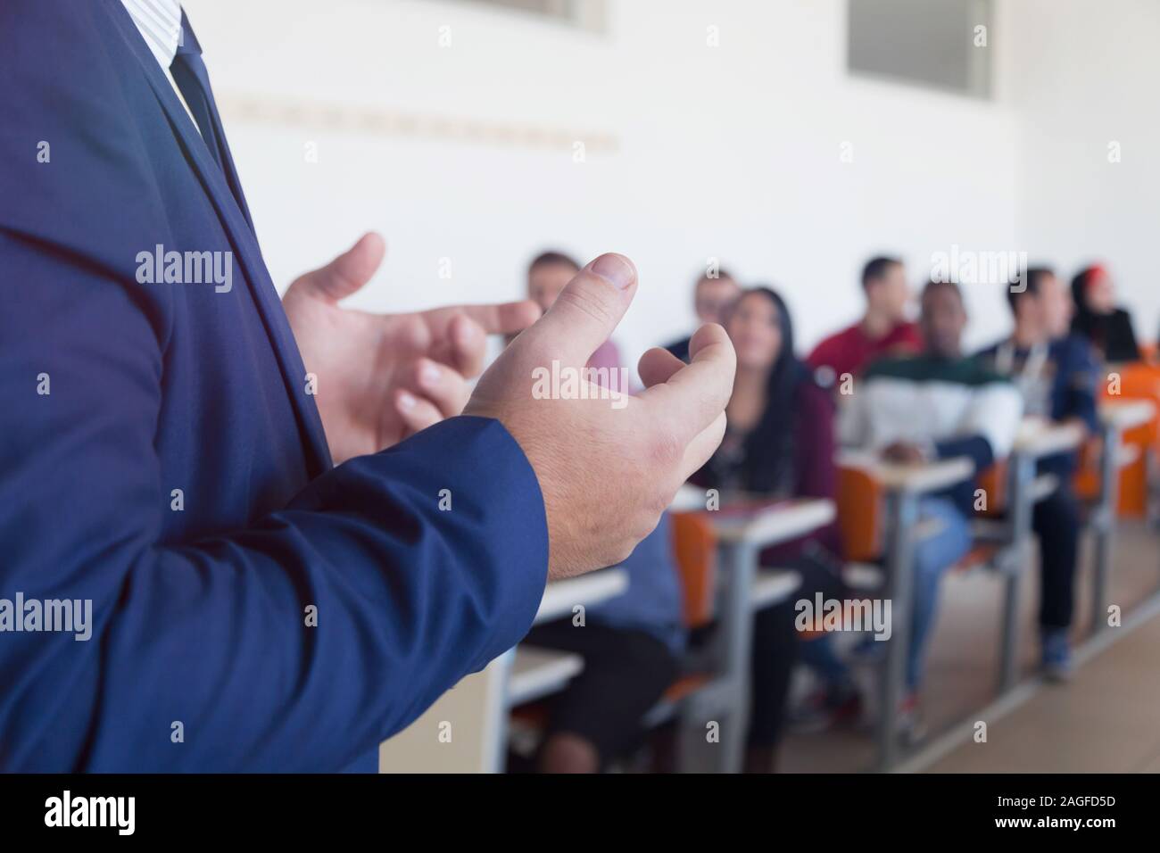 Male professor explain lesson to students and interact with them in the ...