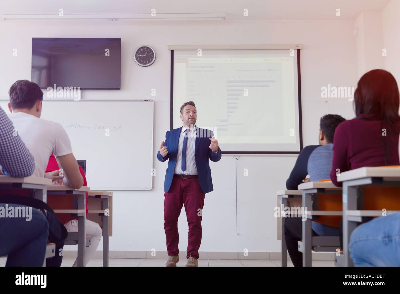 Male professor explain lesson to students and interact with them in the ...