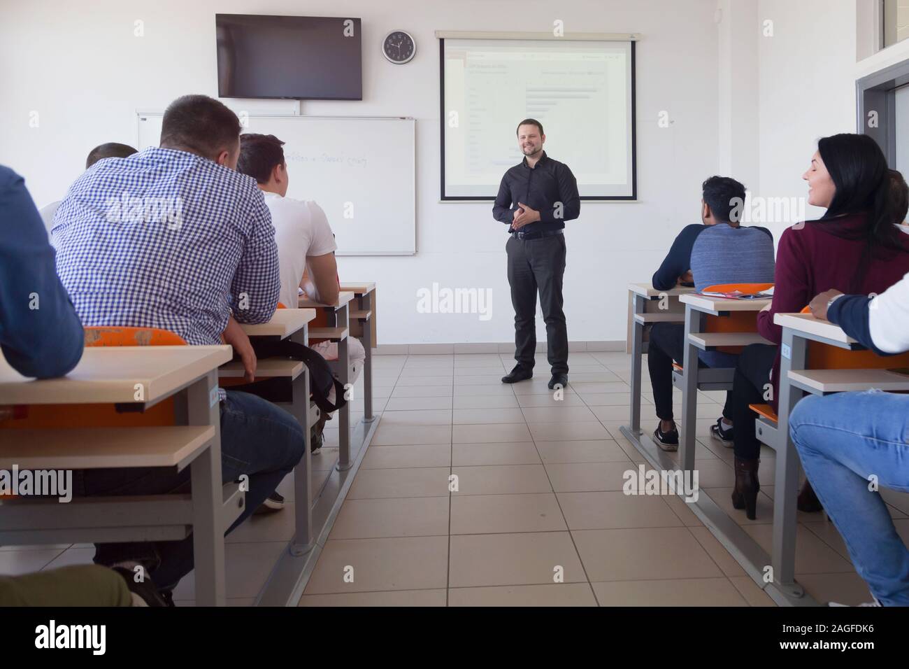 Male professor explain lesson to students and interact with them in the ...