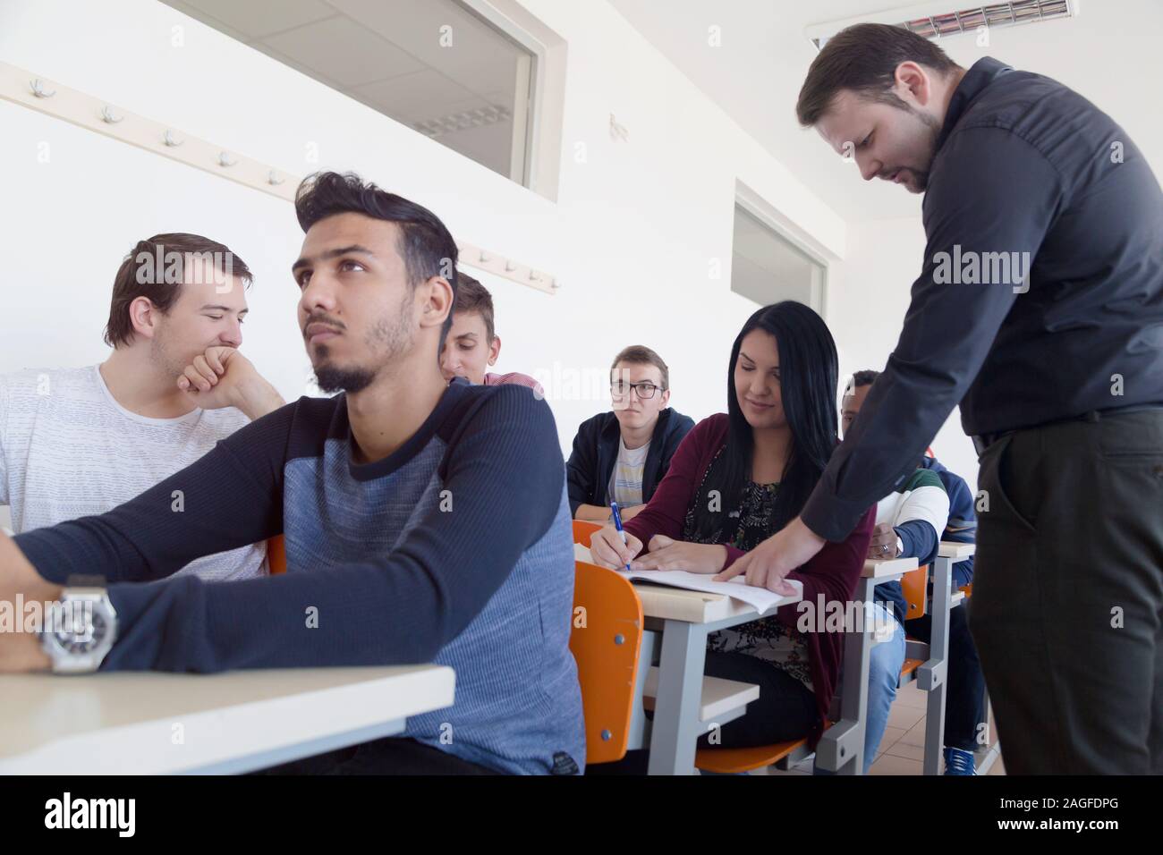 Male professor explain lesson to students and interact with them in the ...