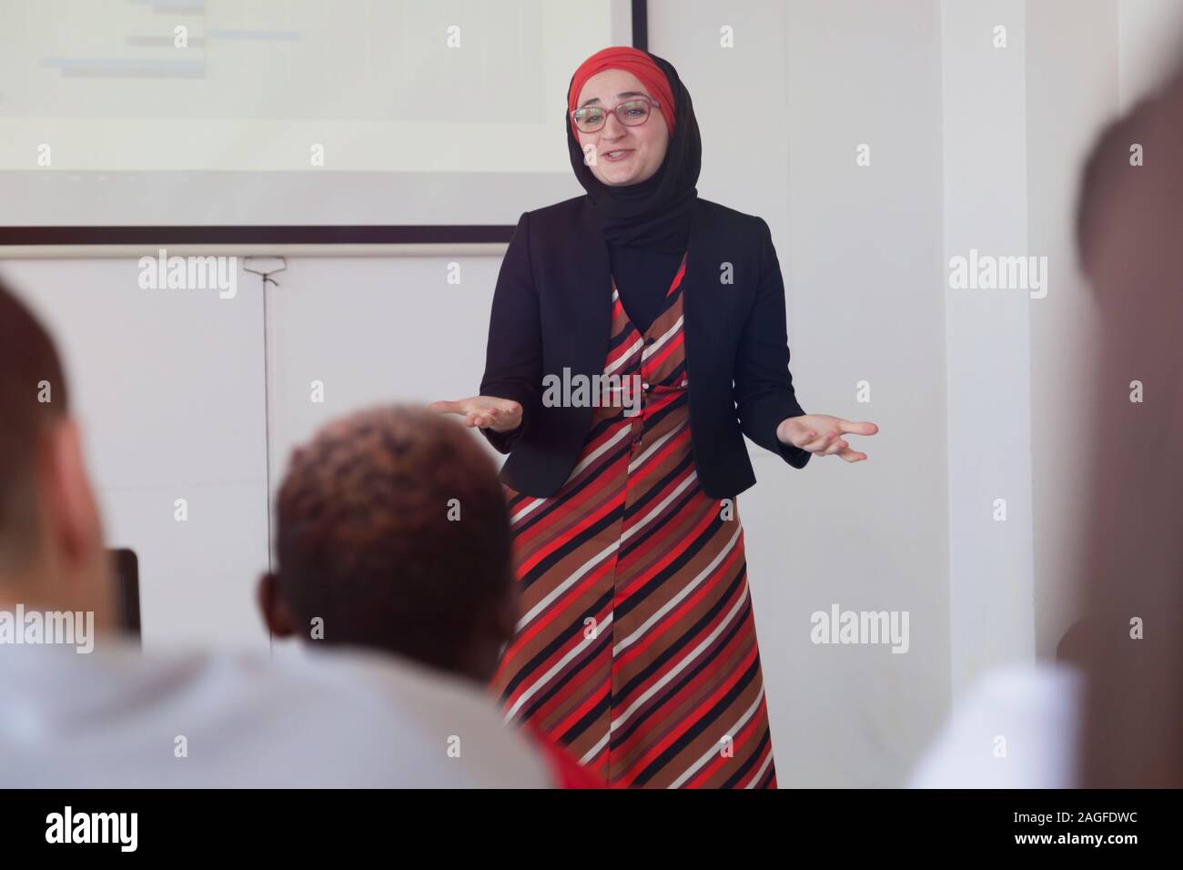 Female muslim professor explain lesson to students and interact with ...