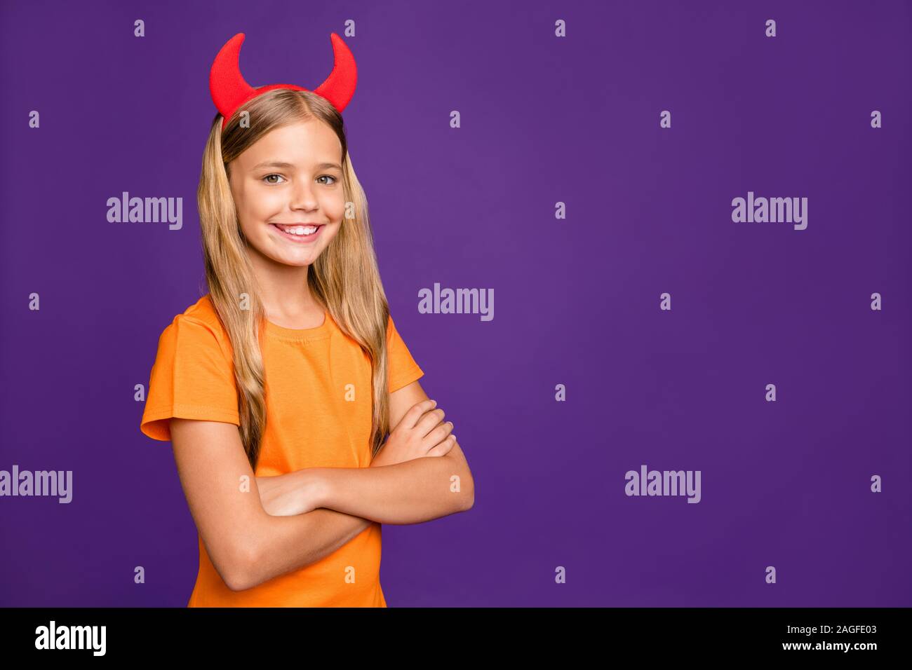 Photo of funny little lady with long hair and horns headband playing ...