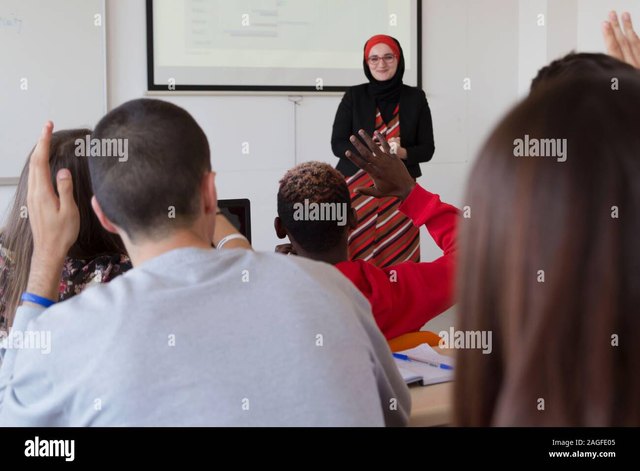 Female muslim professor explain lesson to students and interact with ...
