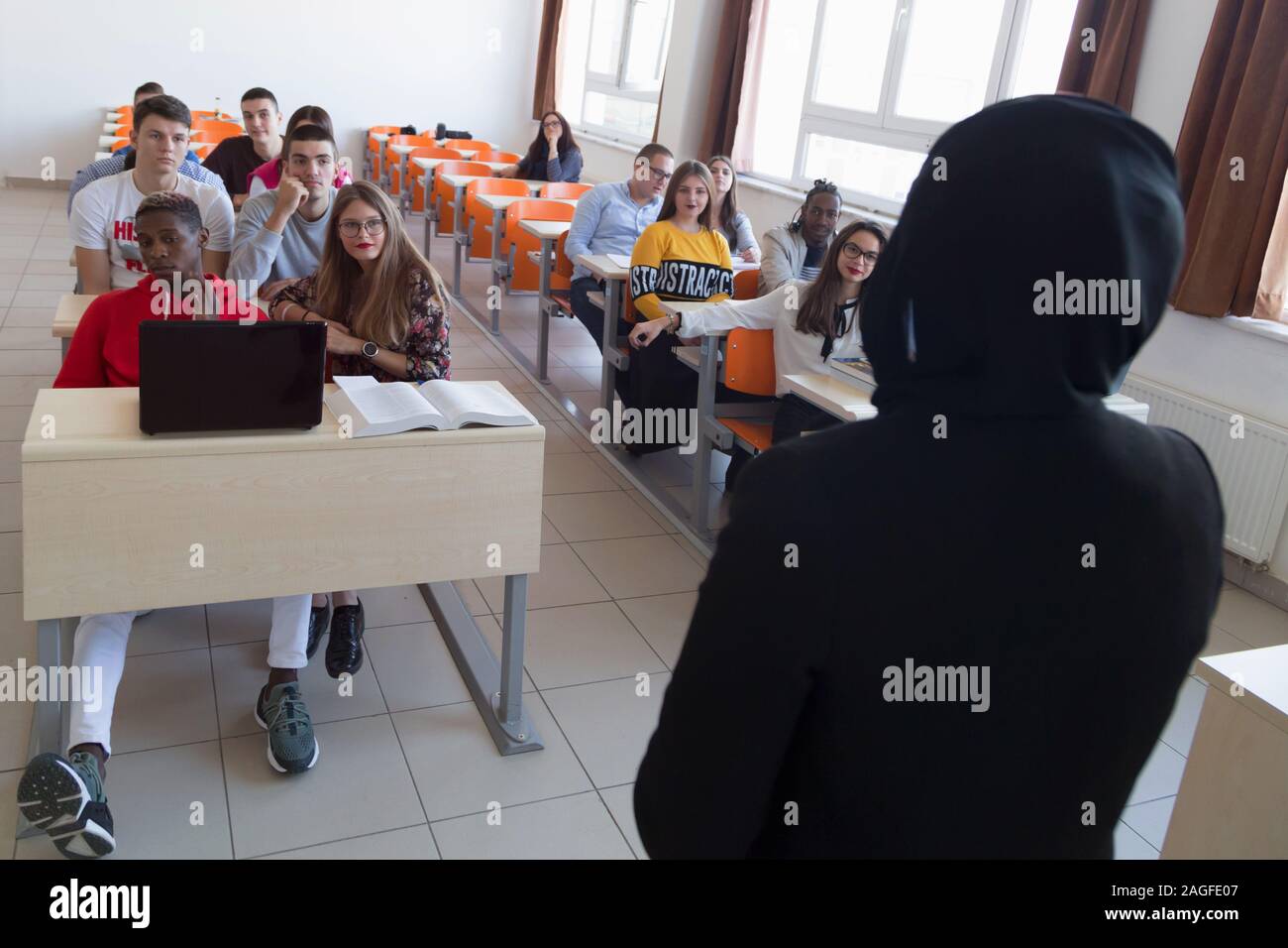 Female muslim professor explain lesson to students and interact with ...
