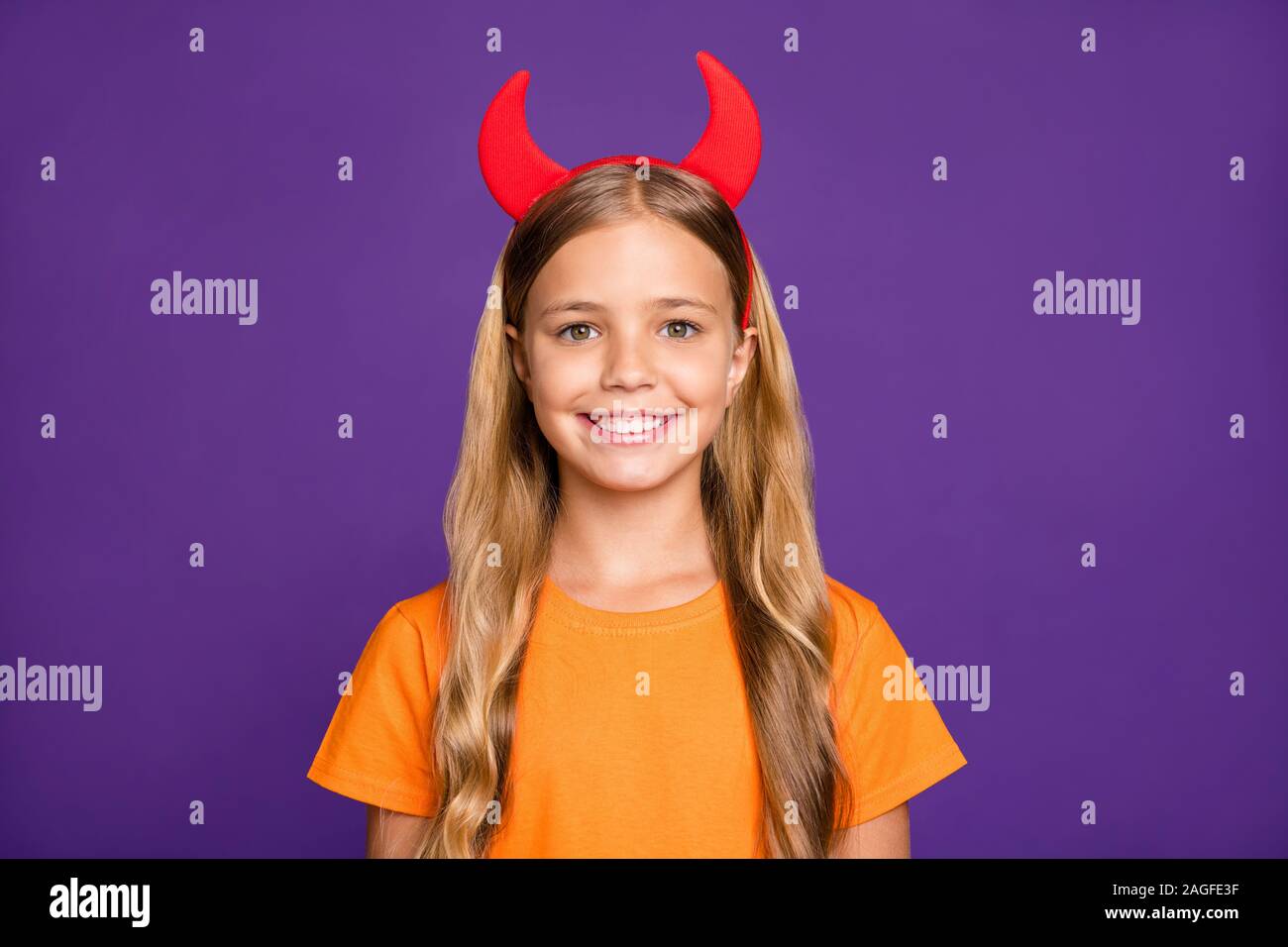 Closeup photo of funny little lady with long hair and headband playing ...