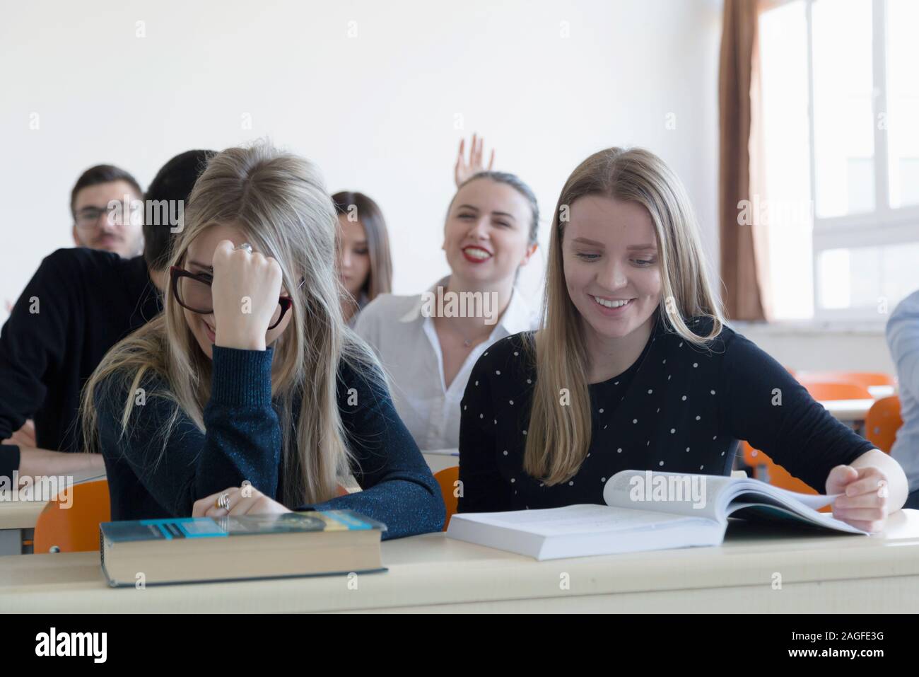 University students listening while Male professor explain lesson to ...