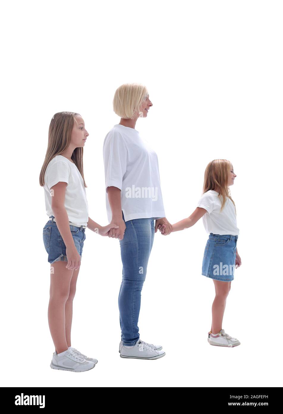 side view . mom and daughters going together Stock Photo - Alamy