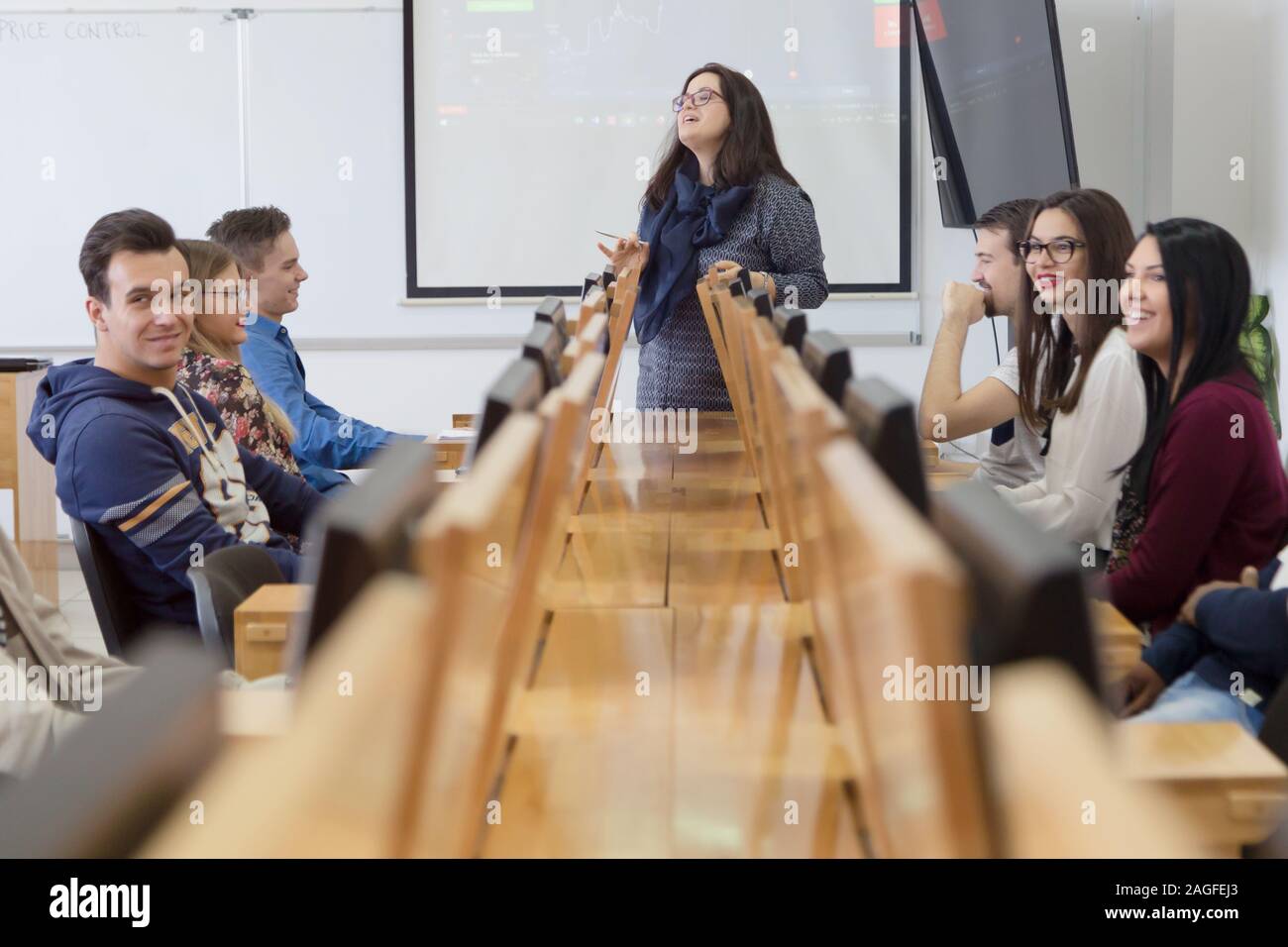 Female professor explain lesson to students and interact with them in ...