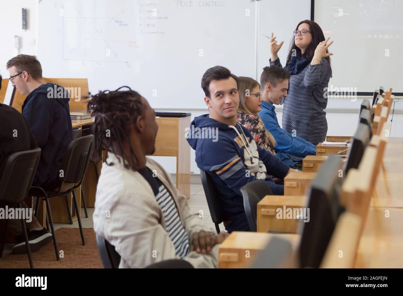 Female professor explain lesson to students and interact with them in ...