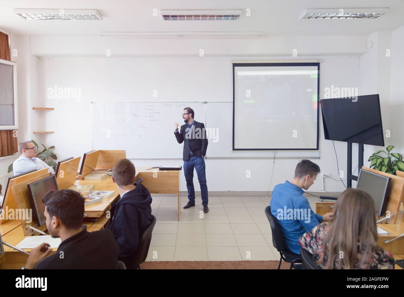 Male professor explain lesson to students and interact with them in the ...