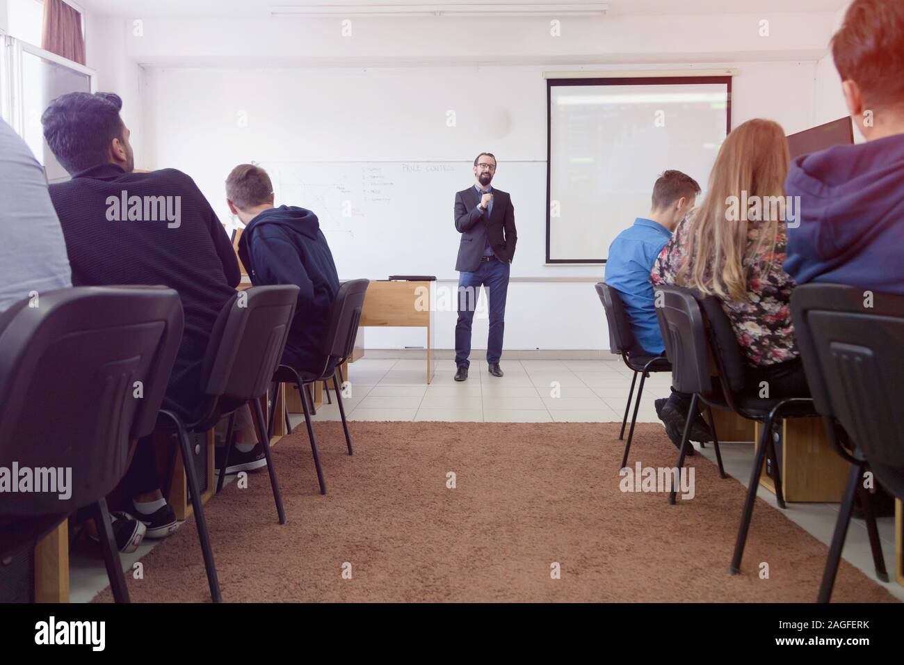 Male professor explain lesson to students and interact with them in the ...