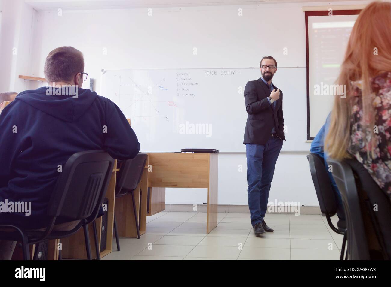 Male professor explain lesson to students and interact with them in the ...