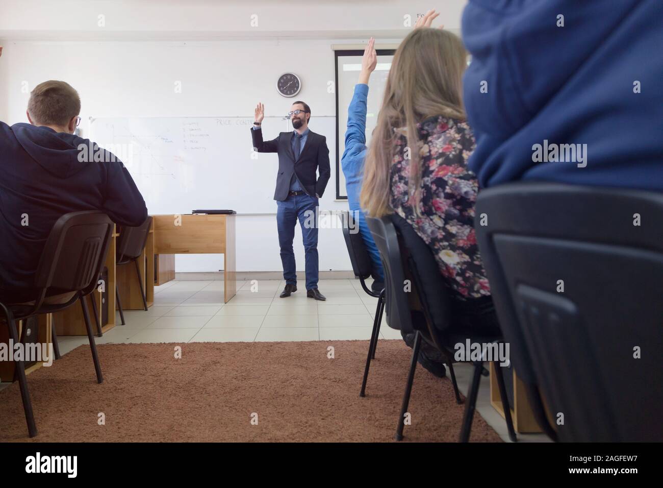 Male professor explain lesson to students and interact with them in the ...
