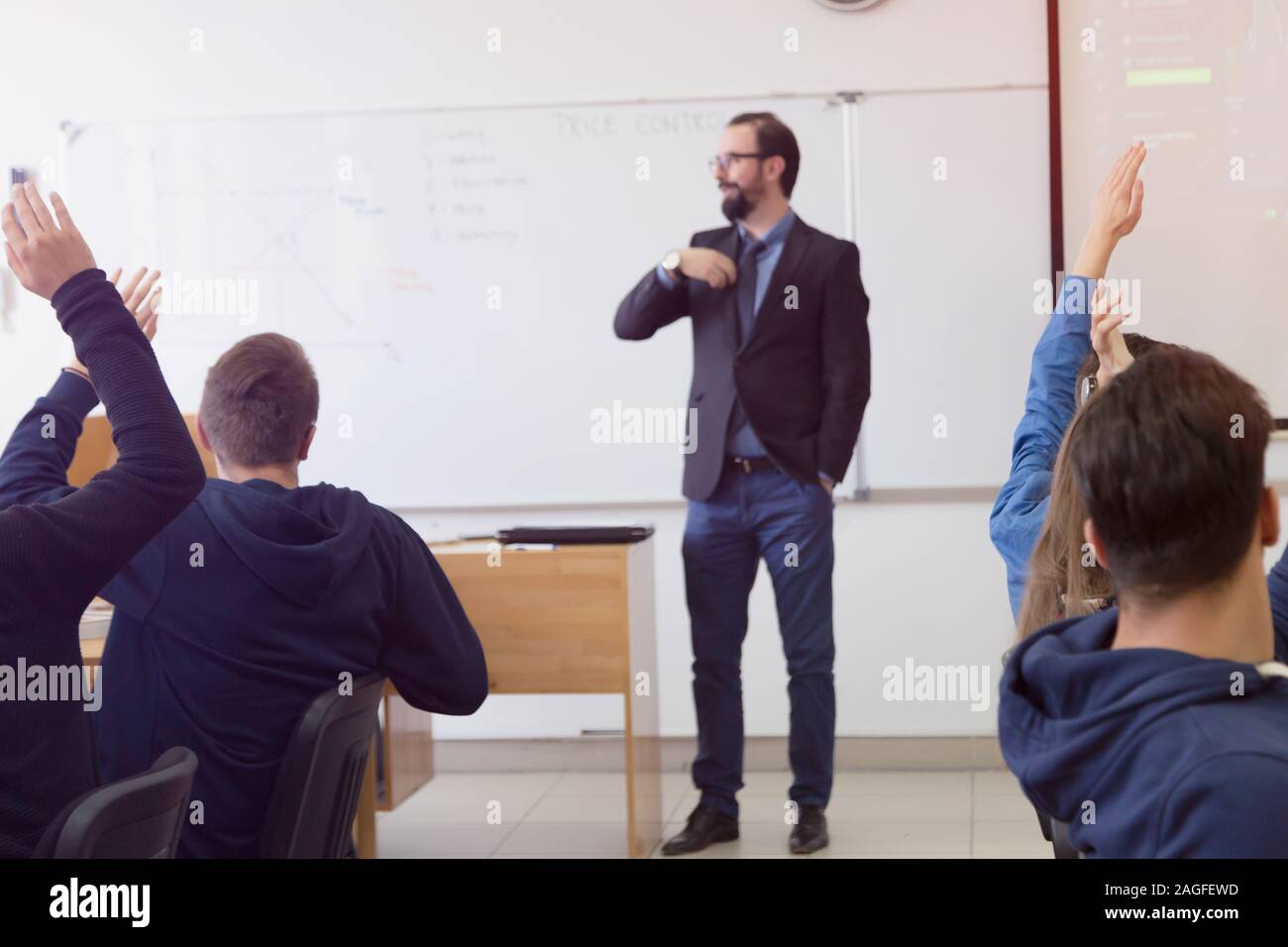 Male professor explain lesson to students and interact with them in the ...