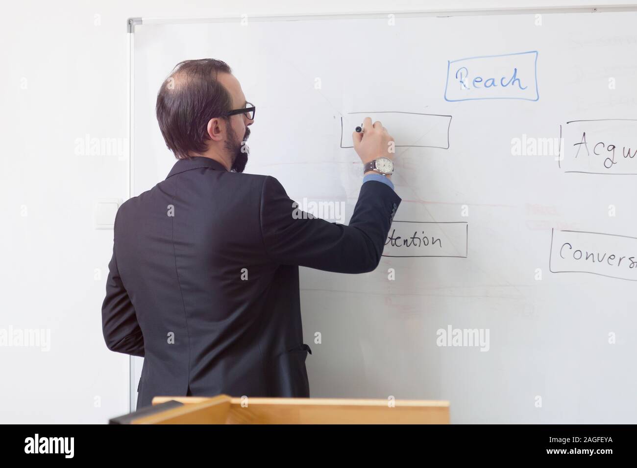 Male professor explain lesson to students and interact with them in the ...
