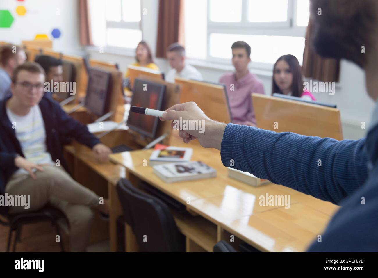 Female Teacher Teaching Her Students In A Classroom High Resolution ...
