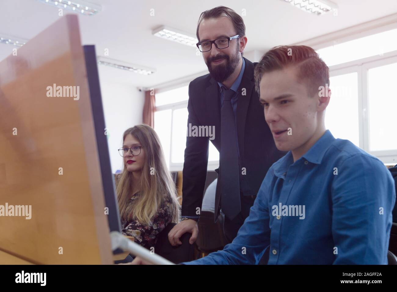 Male professor explain lesson to students and interact with them in the ...