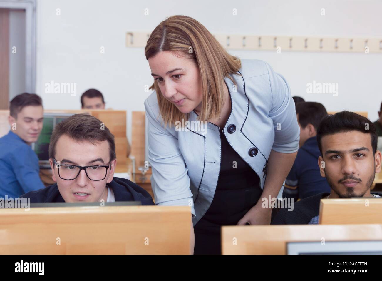 Female attractive professor explain lesson to students and interact ...