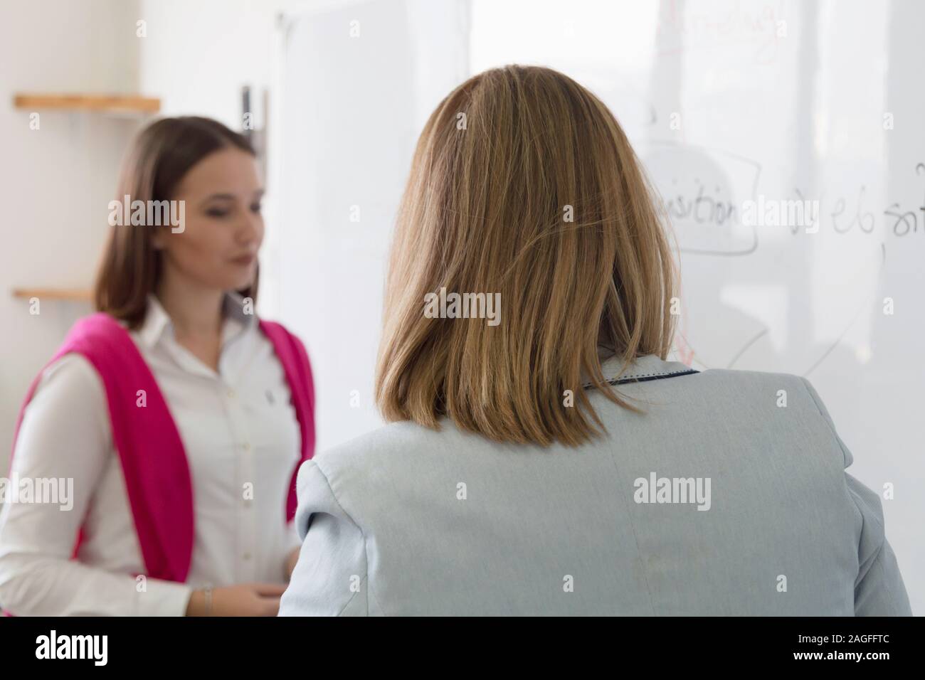 Female attractive professor explain lesson to students and interact ...