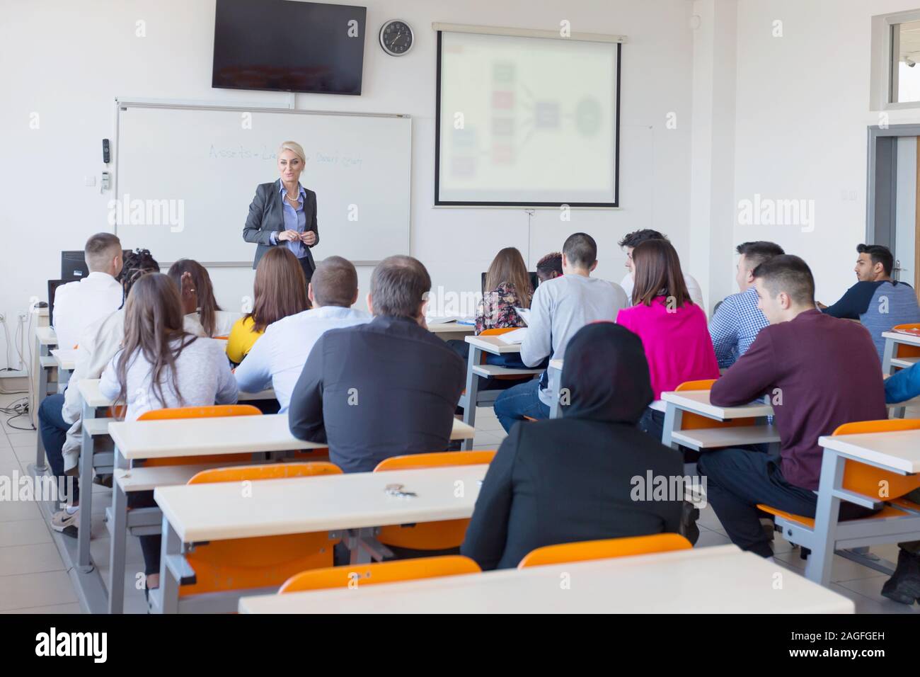 Female attractive professor explain lesson to students and interact ...