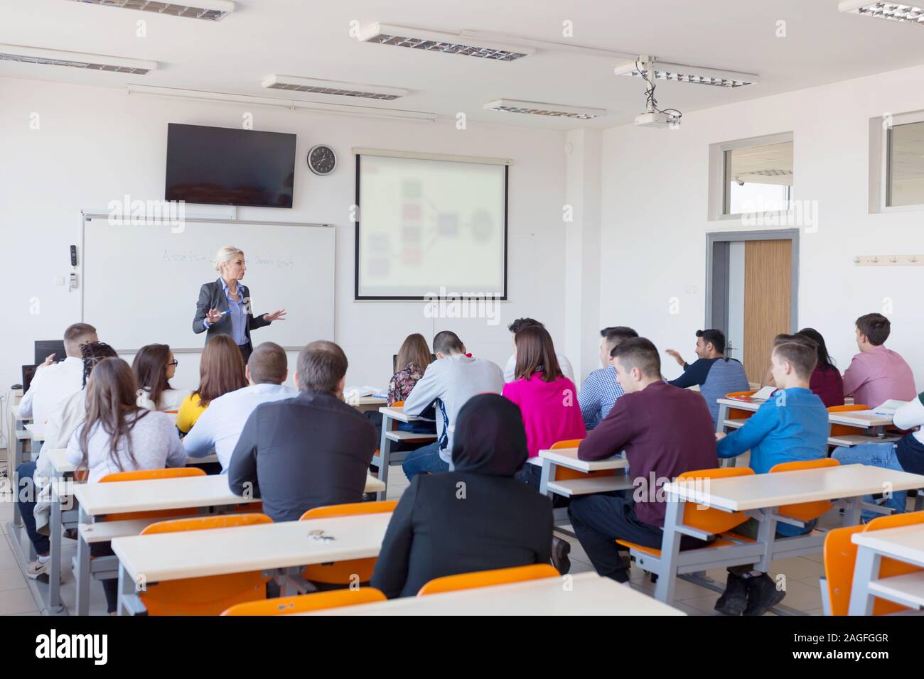 Female attractive professor explain lesson to students and interact ...