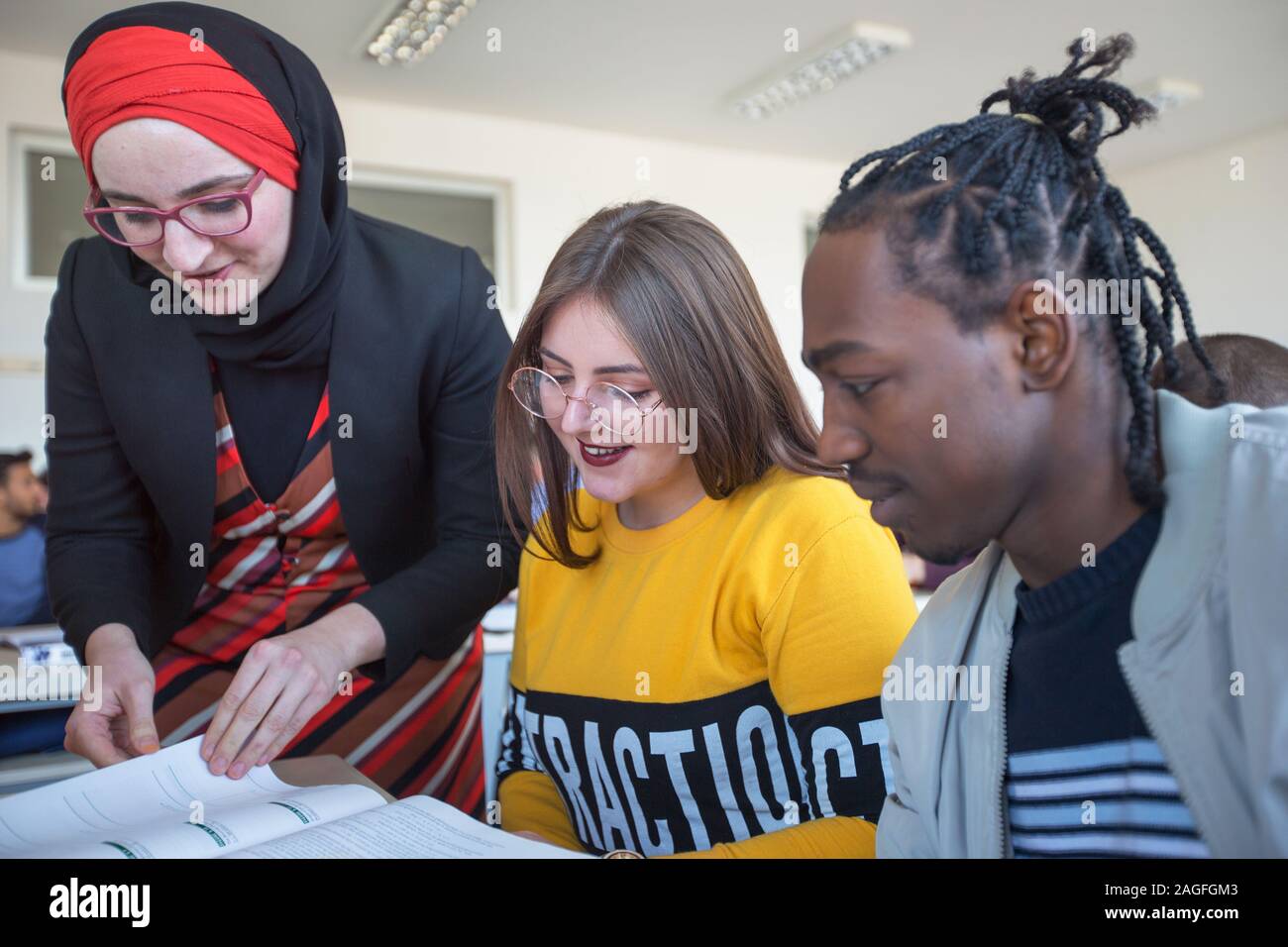 Female muslim professor explain lesson to students and interact with ...