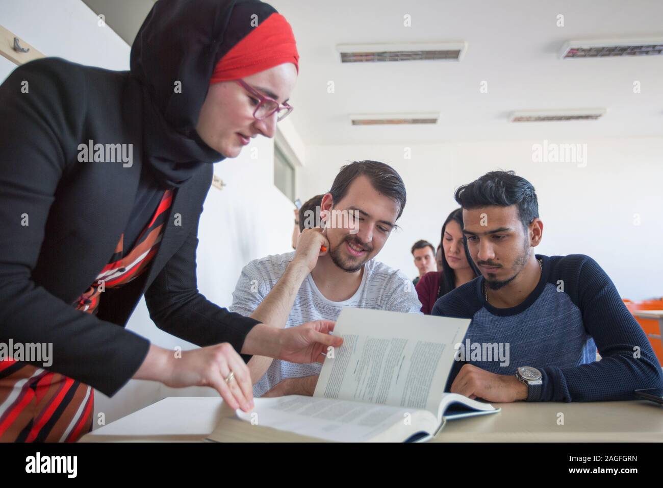 Female muslim professor explain lesson to students and interact with ...