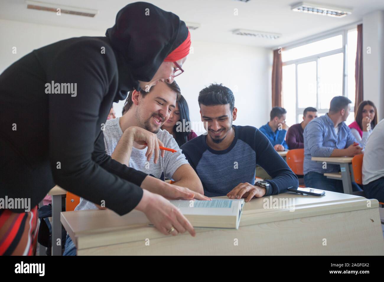 Female muslim professor explain lesson to students and interact with ...