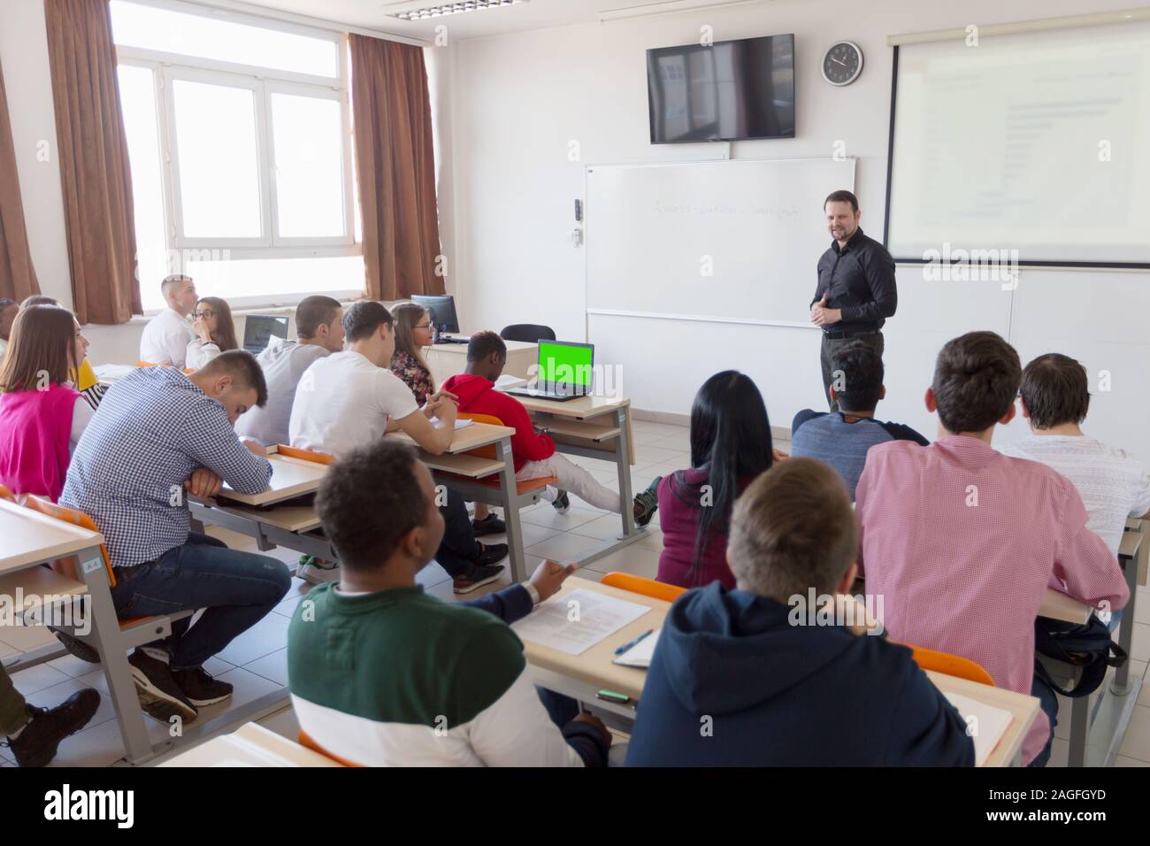 Male professor explain lesson to students and interact with them in the ...