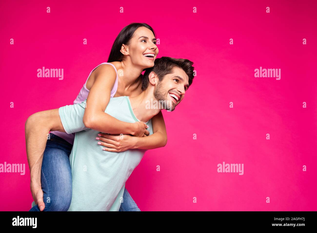 Photo of funny guy and lady holding piggyback spending free time ...